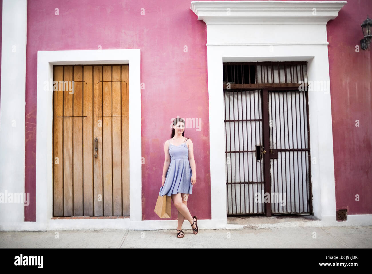 Puerto Rico, San Juan, Woman with shopping bag standing in front of ...