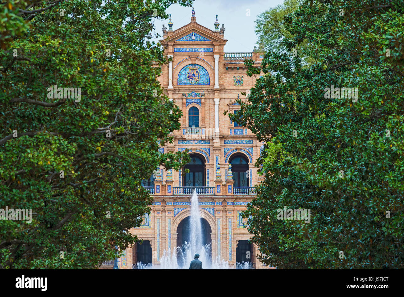 Spain, Seville, Plaza De Espana, Fountain among trees, building in ...