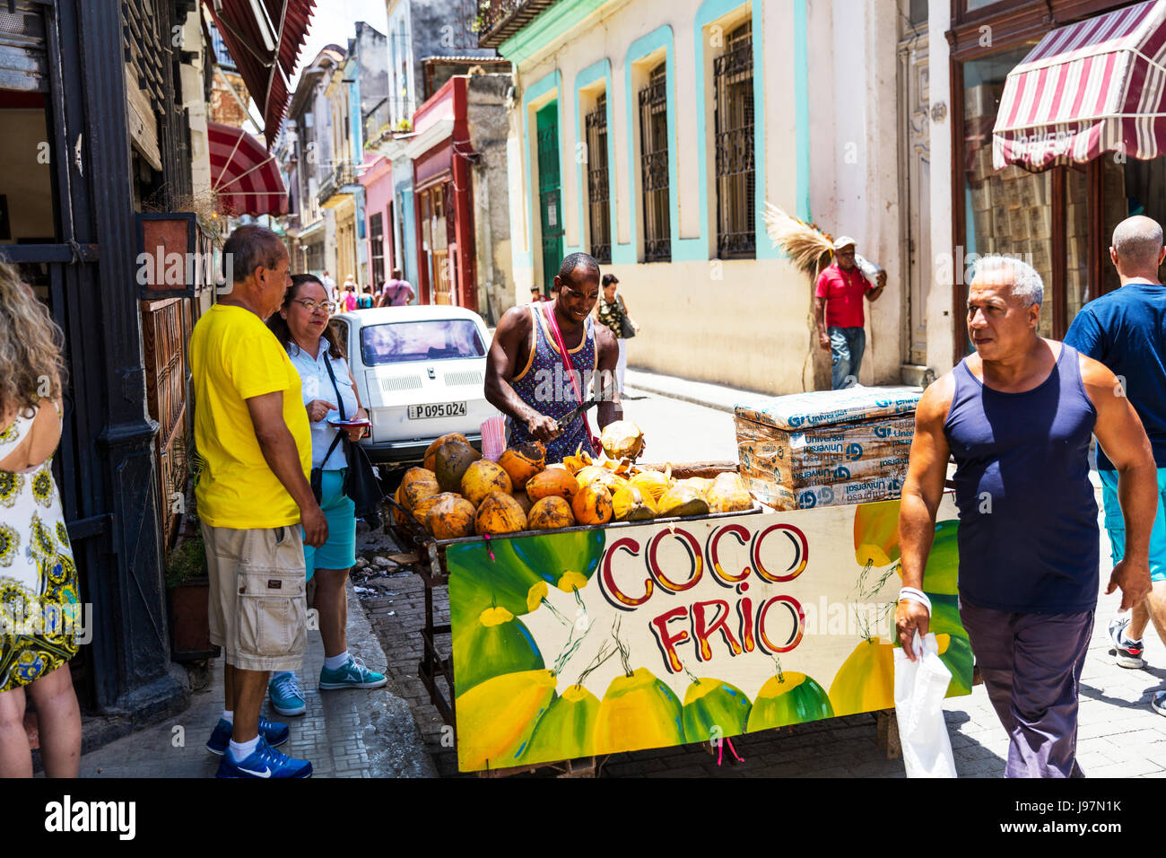 Man selling coconut drink direct from coconut, Cuban man with coconuts ...