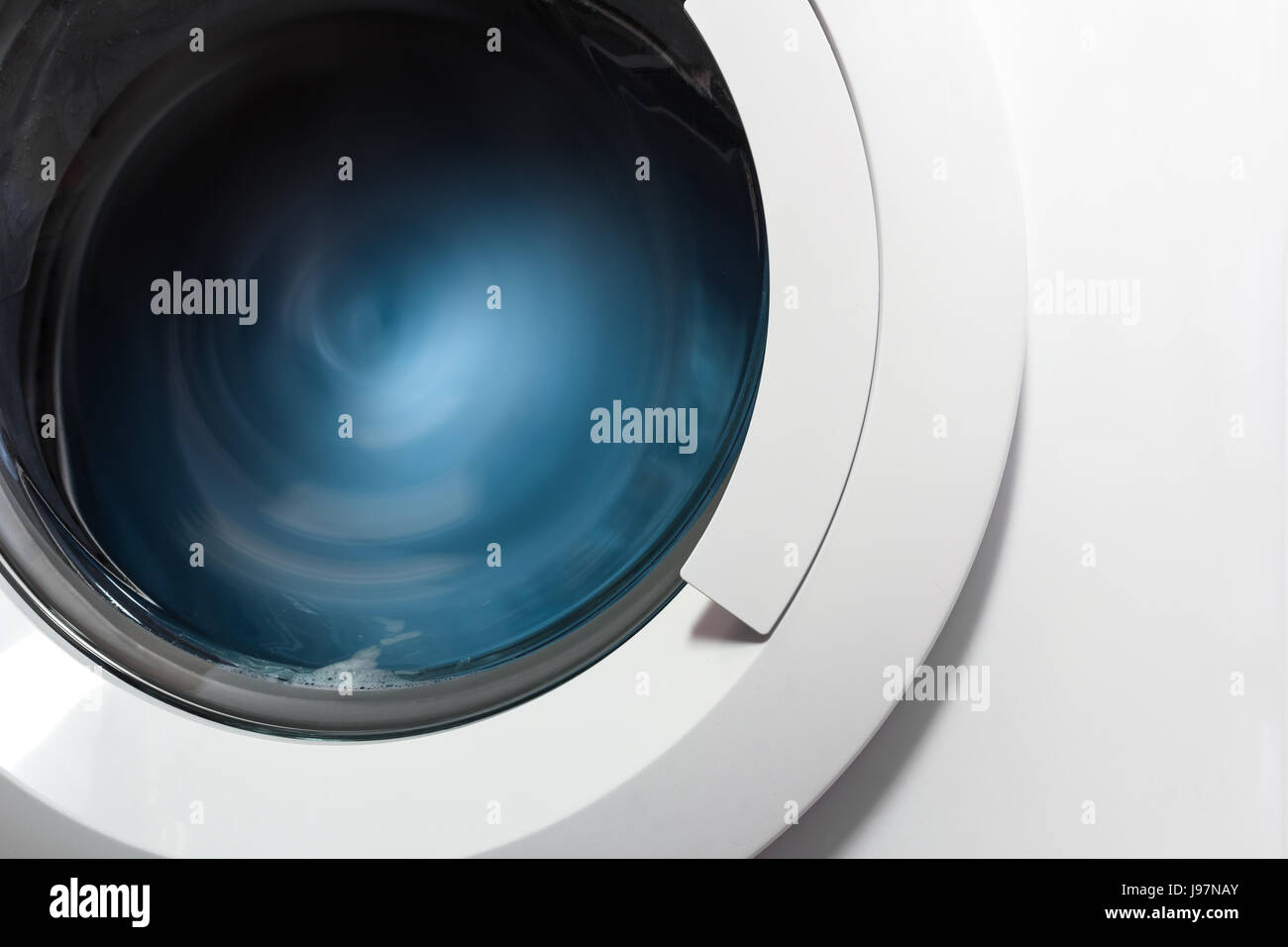 Front view and portion of the porthole of the washing machine during ...