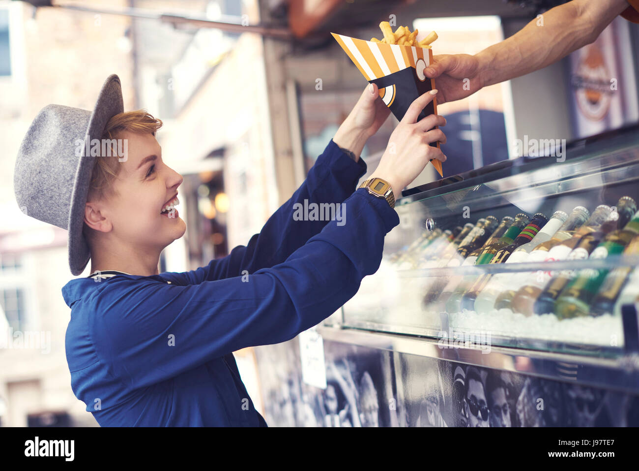 Female customer reaching food from vendor Stock Photo - Alamy