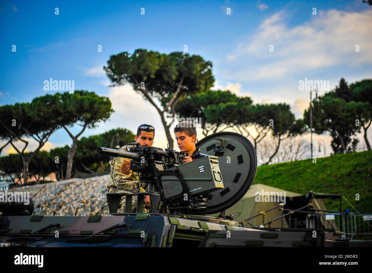 A young boy playing with a heavy machine gun Stock Photo - Alamy