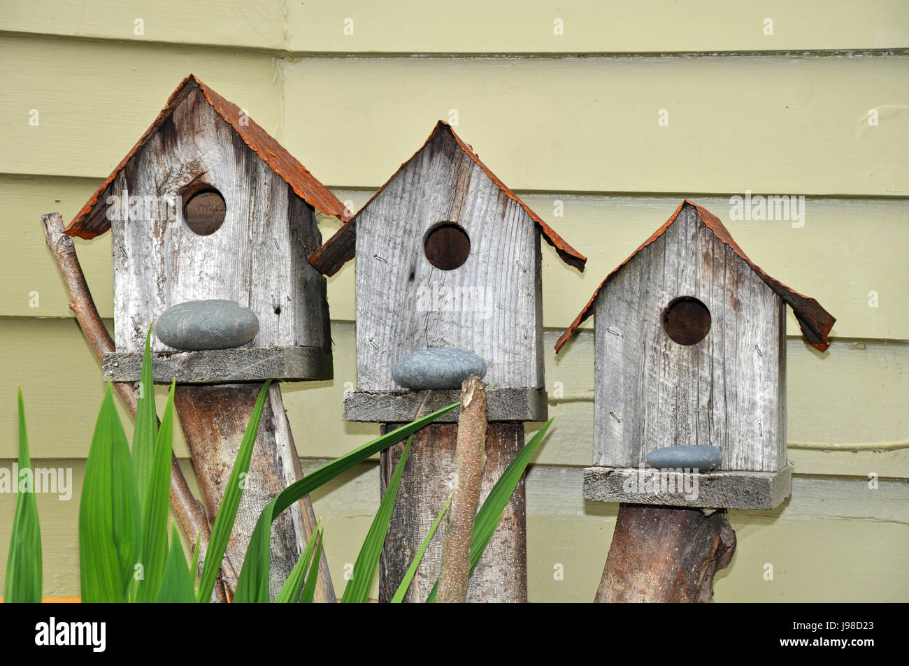 Three little wooden birdhouses Stock Photo - Alamy