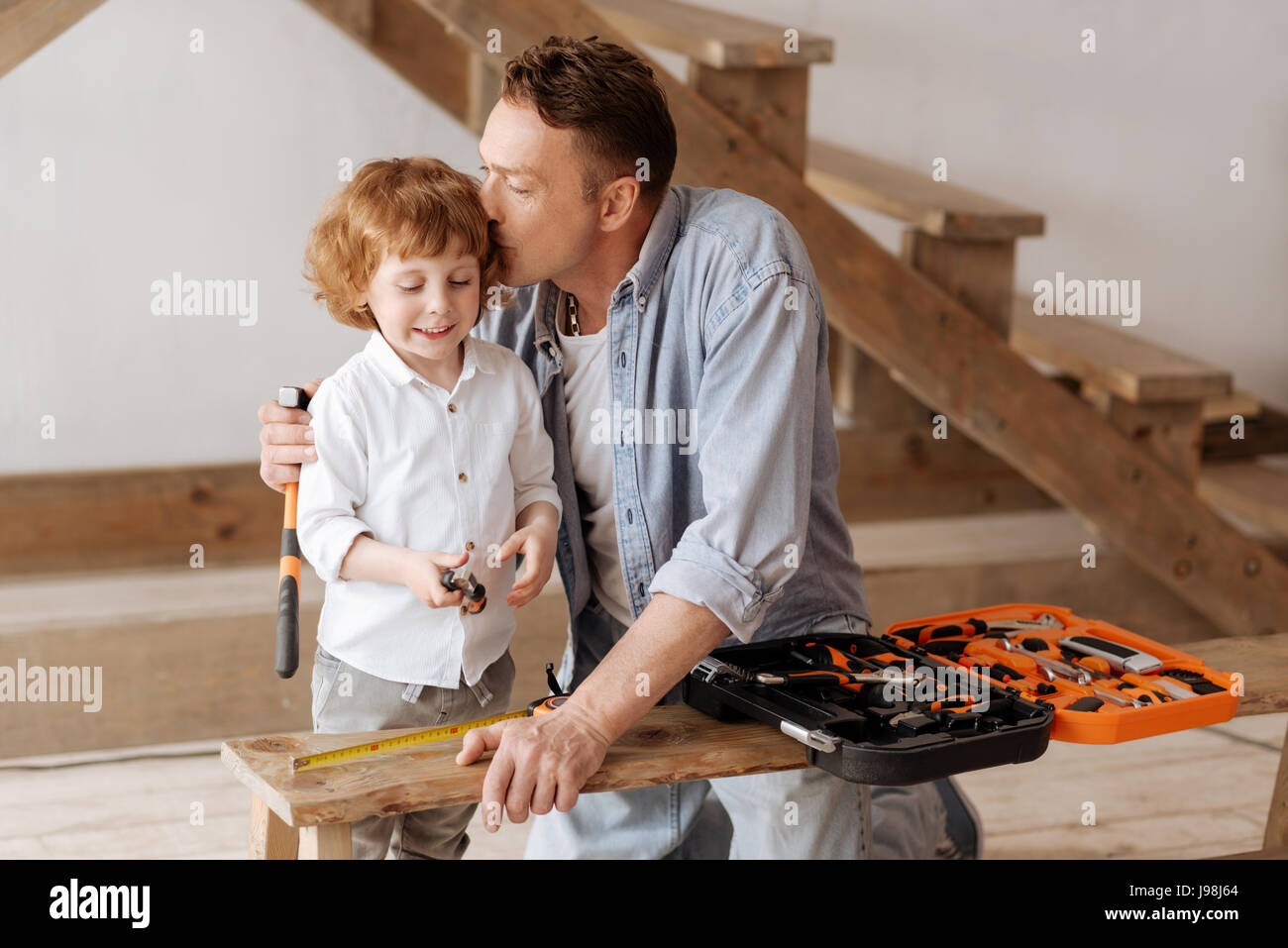 Positive male kid feeling happiness while being with dad Stock Photo ...