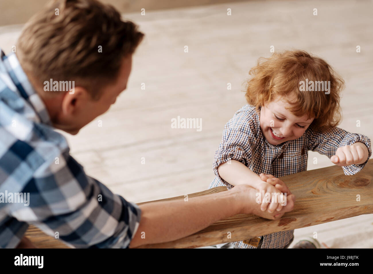 Happy man child winning in arm-wrestling Stock Photo - Alamy