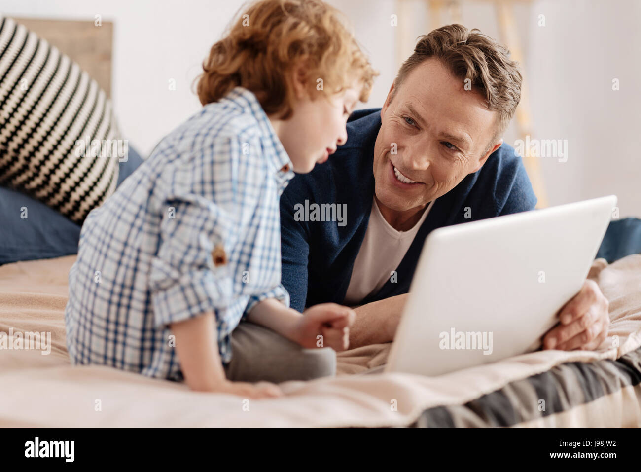 Positive delighted father looking at his child Stock Photo - Alamy