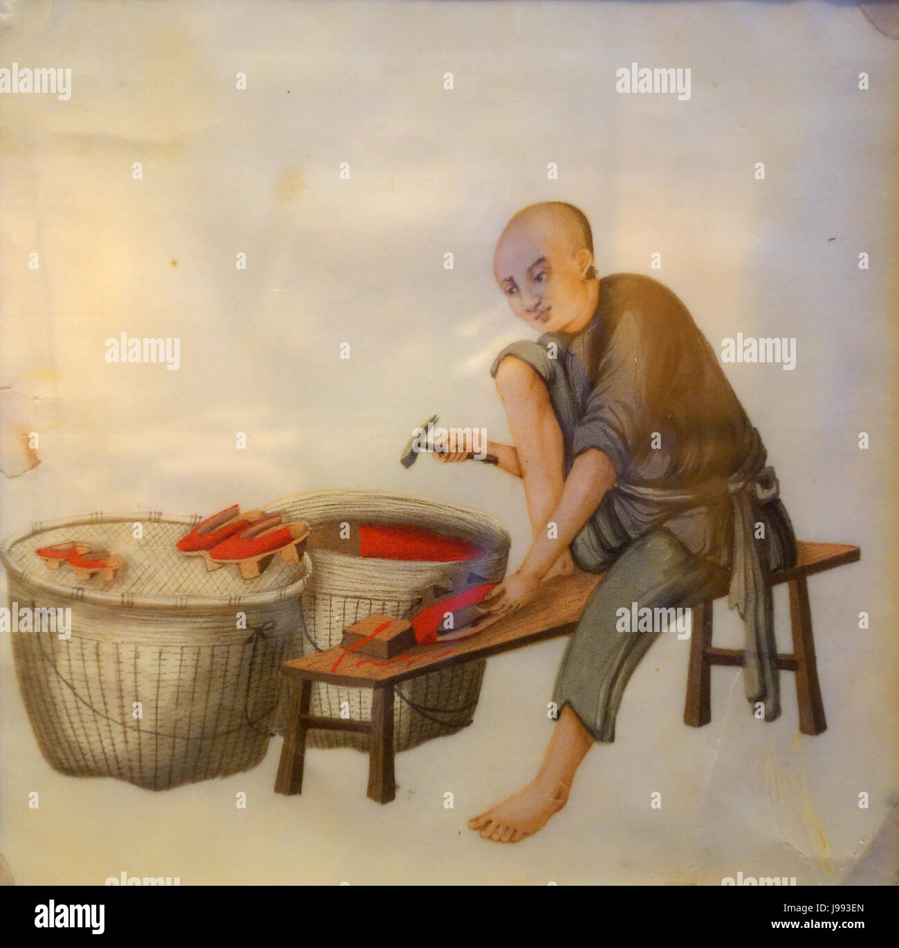 A photograph of a traditional Chinese shoemaker working on Tetrapanax ...