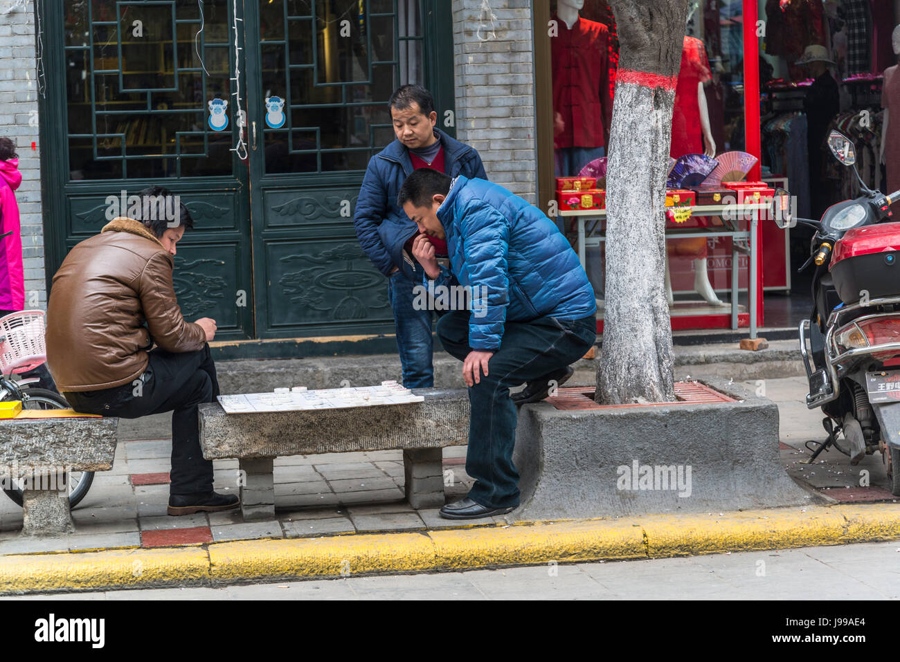 Men playing draughts in the street, Culture Street, known for local ...