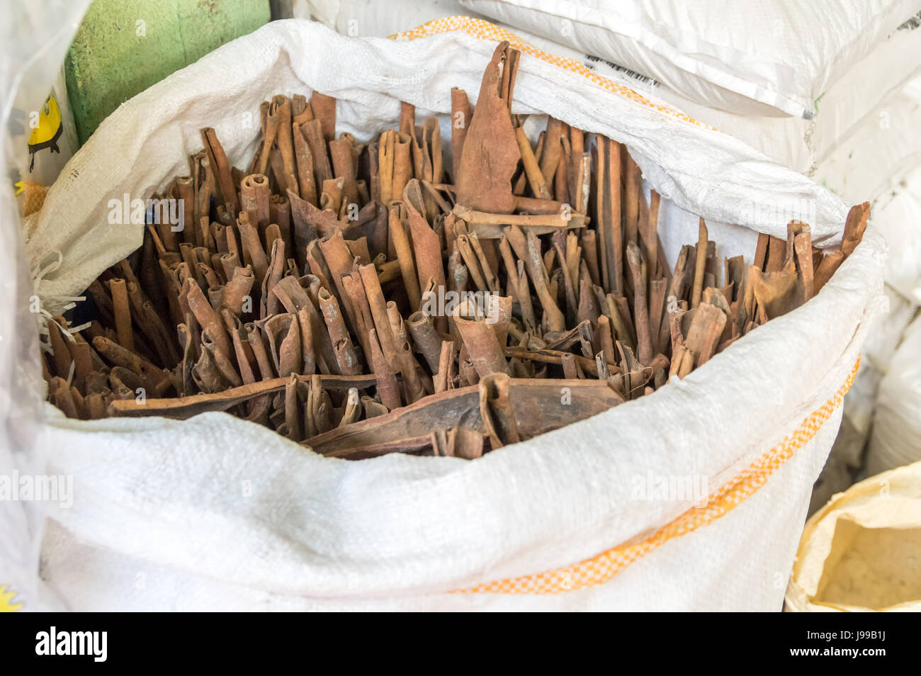 Raw cinnamon displayed in bags for sale at a market Stock Photo - Alamy