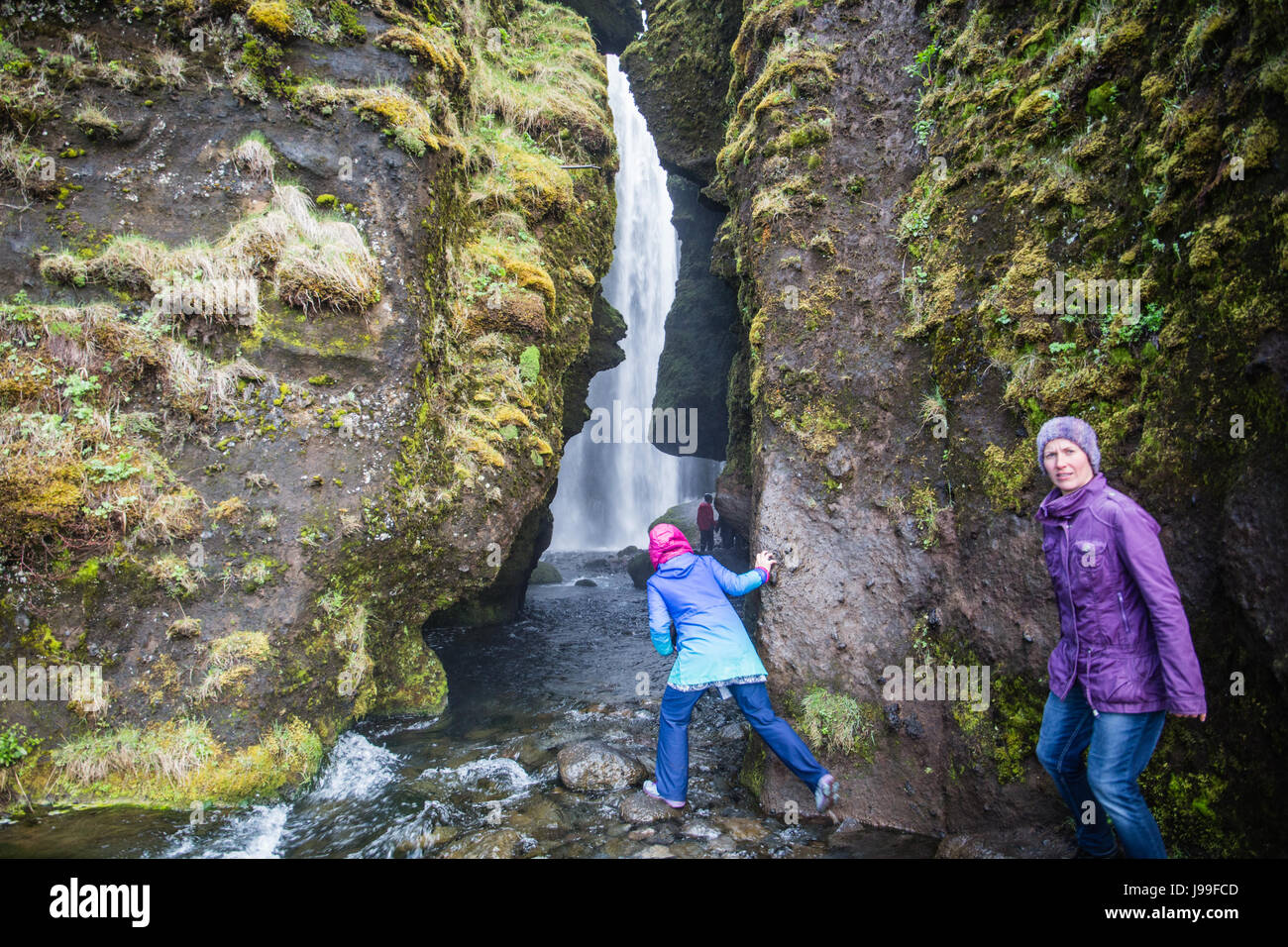 Female Tourists at Gljufrabui Waterfalls Gljúfrabúi near Seljalandsfoss ...