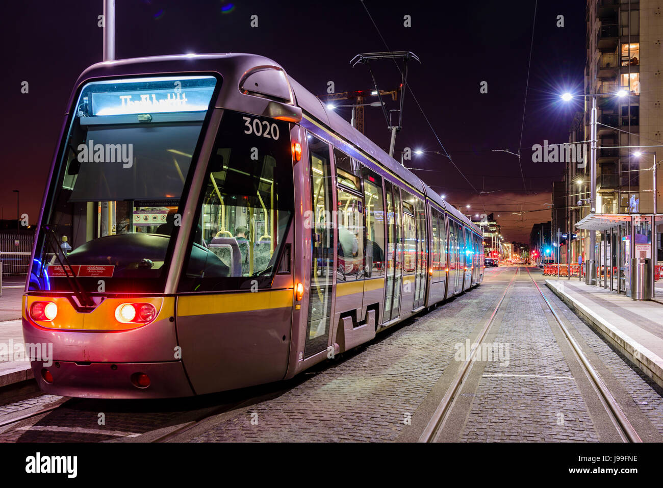 Luas Tram light railway in Dublin at night, Ireland, which carries over ...