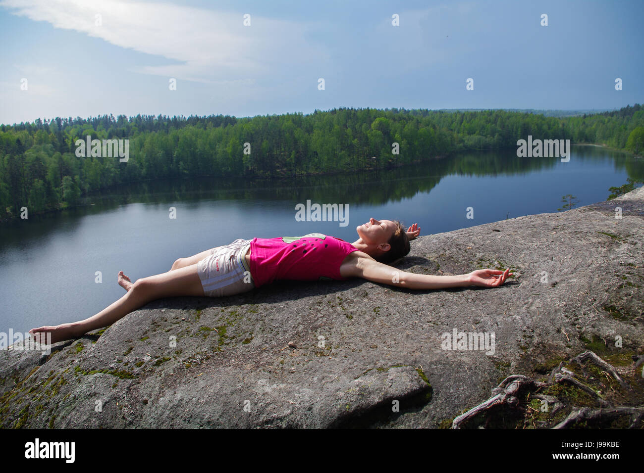Girl laying on rocks hi-res stock photography and images - Alamy