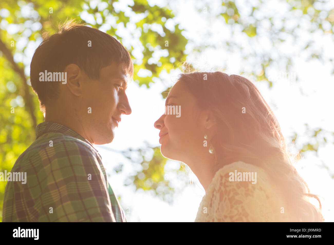 Closeup photo of romantic couple outdoors, side view Stock Photo - Alamy
