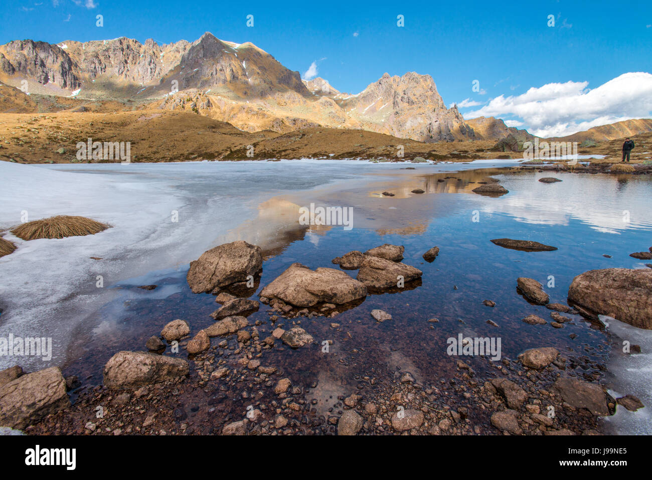 Reflections in partially frozen alpine hi-res stock photography and ...