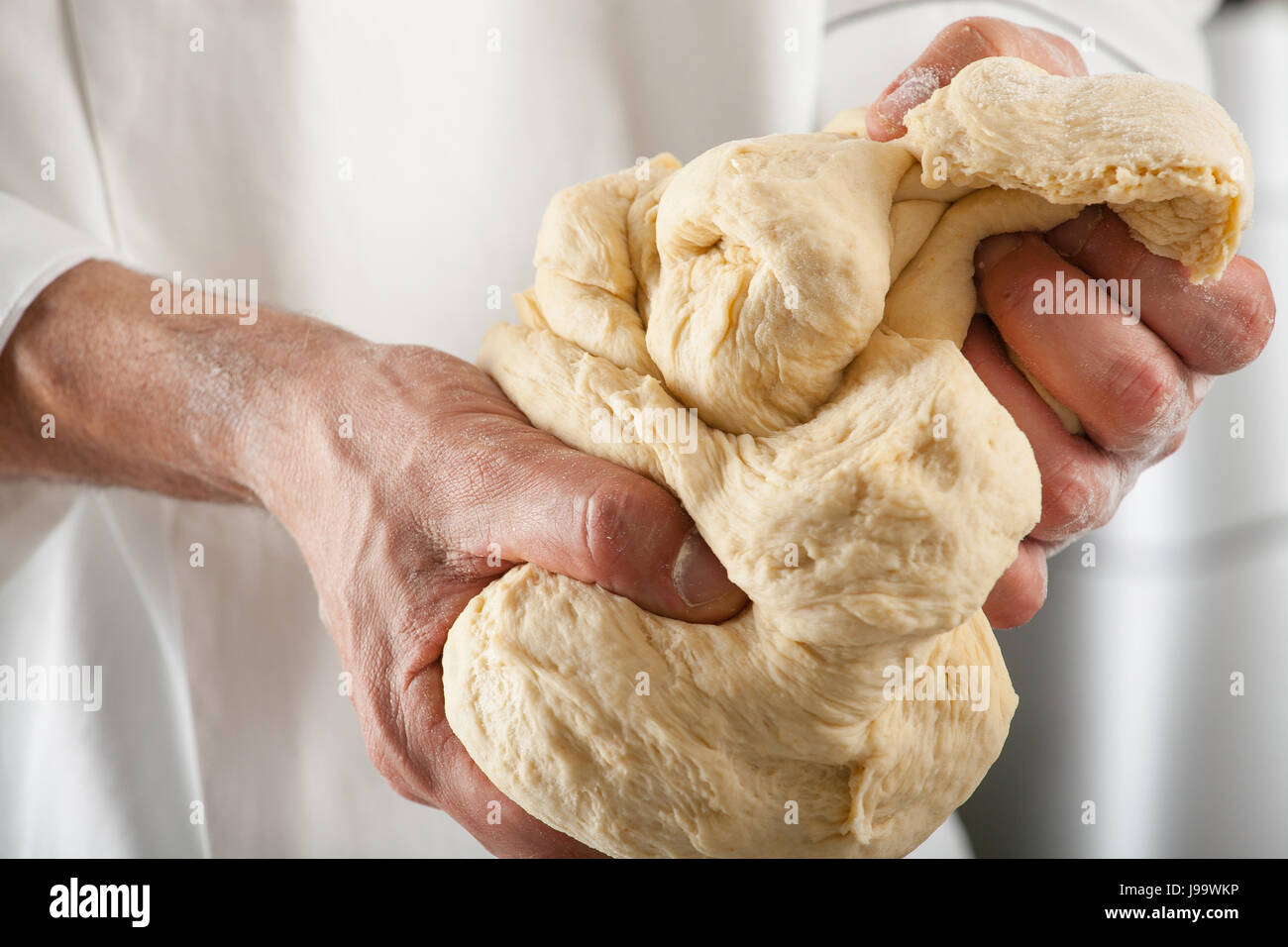 Chef kneading dough, Making dough by male hands at bakery Stock Photo ...