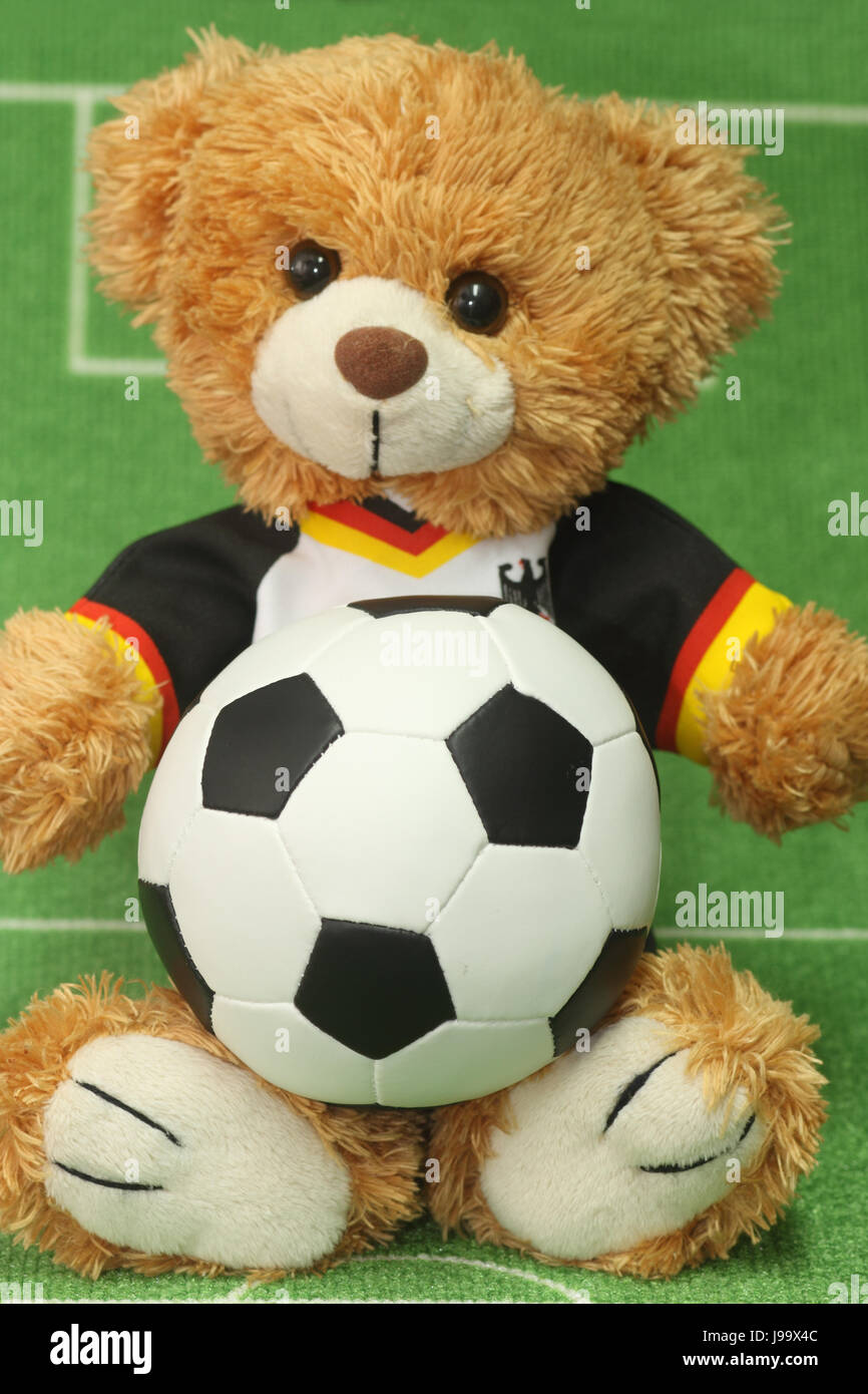 Teddy bear with football shirt on lawn background Stock Photo - Alamy