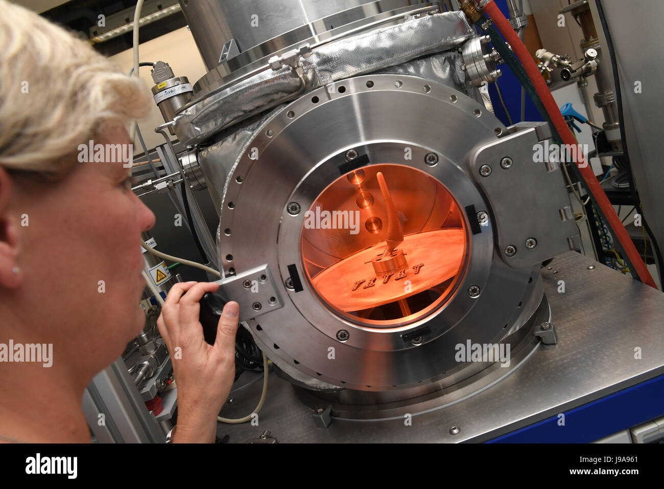 View into the low pressure plasma reactor during the fine cleaning of ...