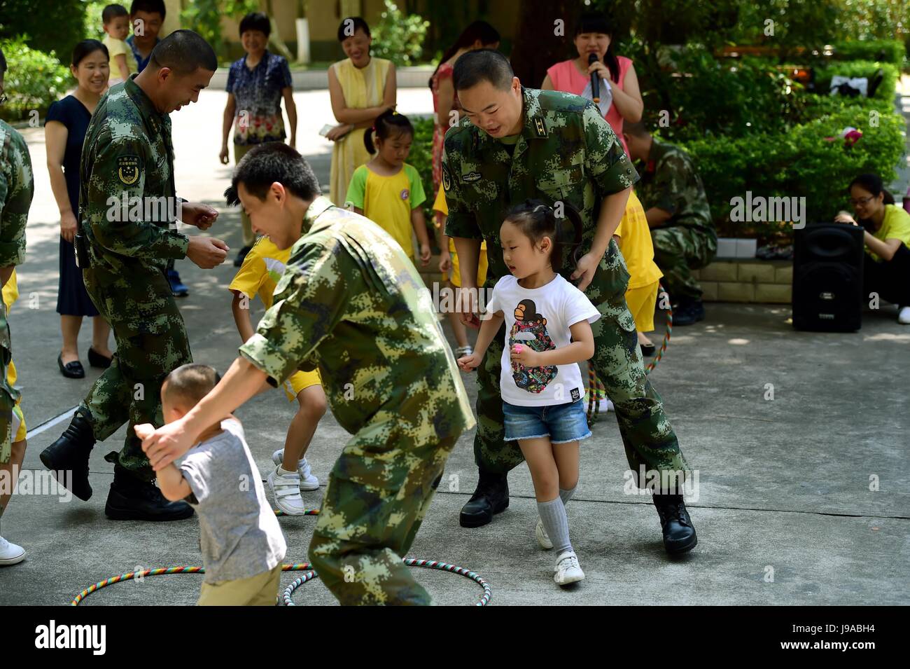 Shenzhen, China. 31st May, 2017. Soldiers' kids have a good time with ...