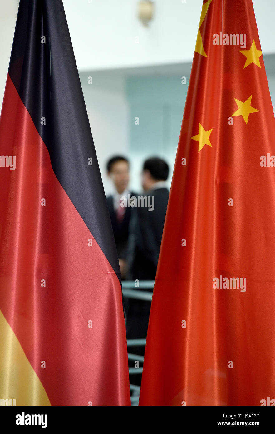 Picture of two people talking in the German Chancellery behind the ...