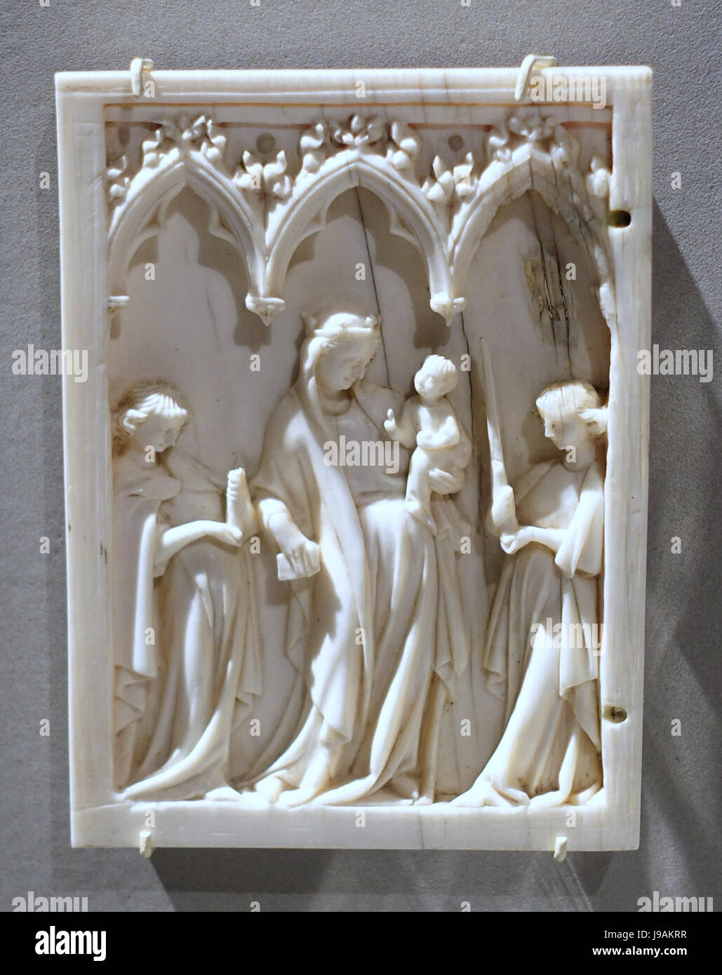 A medieval ivory panel depicting the Virgin and Child surrounded by ...