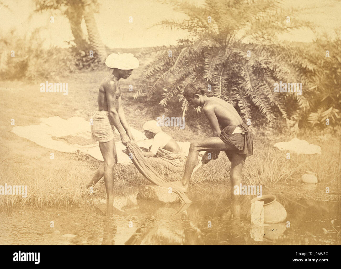 Washermen (dhobis) at work beside a river or pond 1873 Stock Photo - Alamy