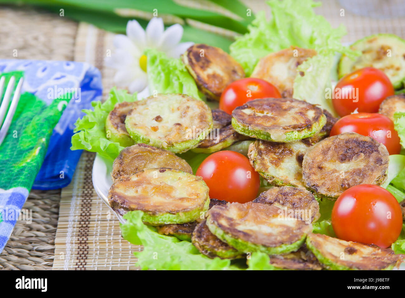 baked vegetable marrows with tomatoes and green sheet lettuce Stock ...