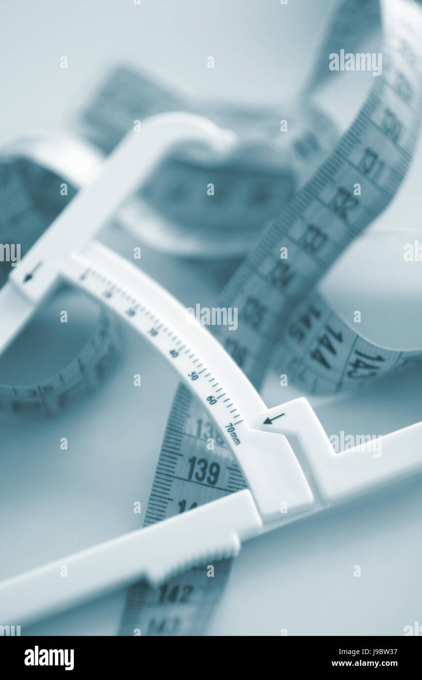 Fat caliper and measuring tape used to measure waistline, bodyfat ...