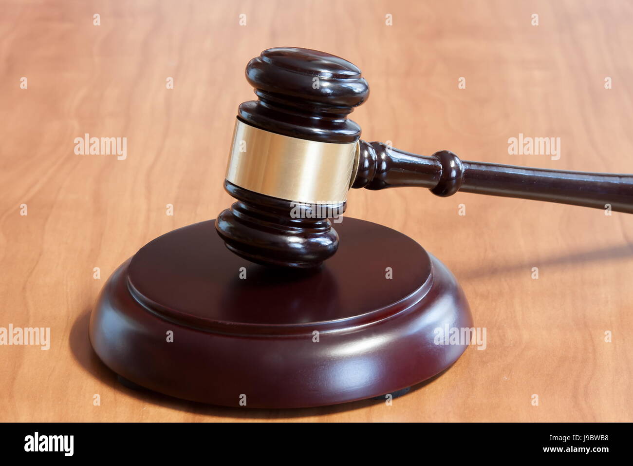 Judicial hammer with a support on a wooden table Stock Photo - Alamy