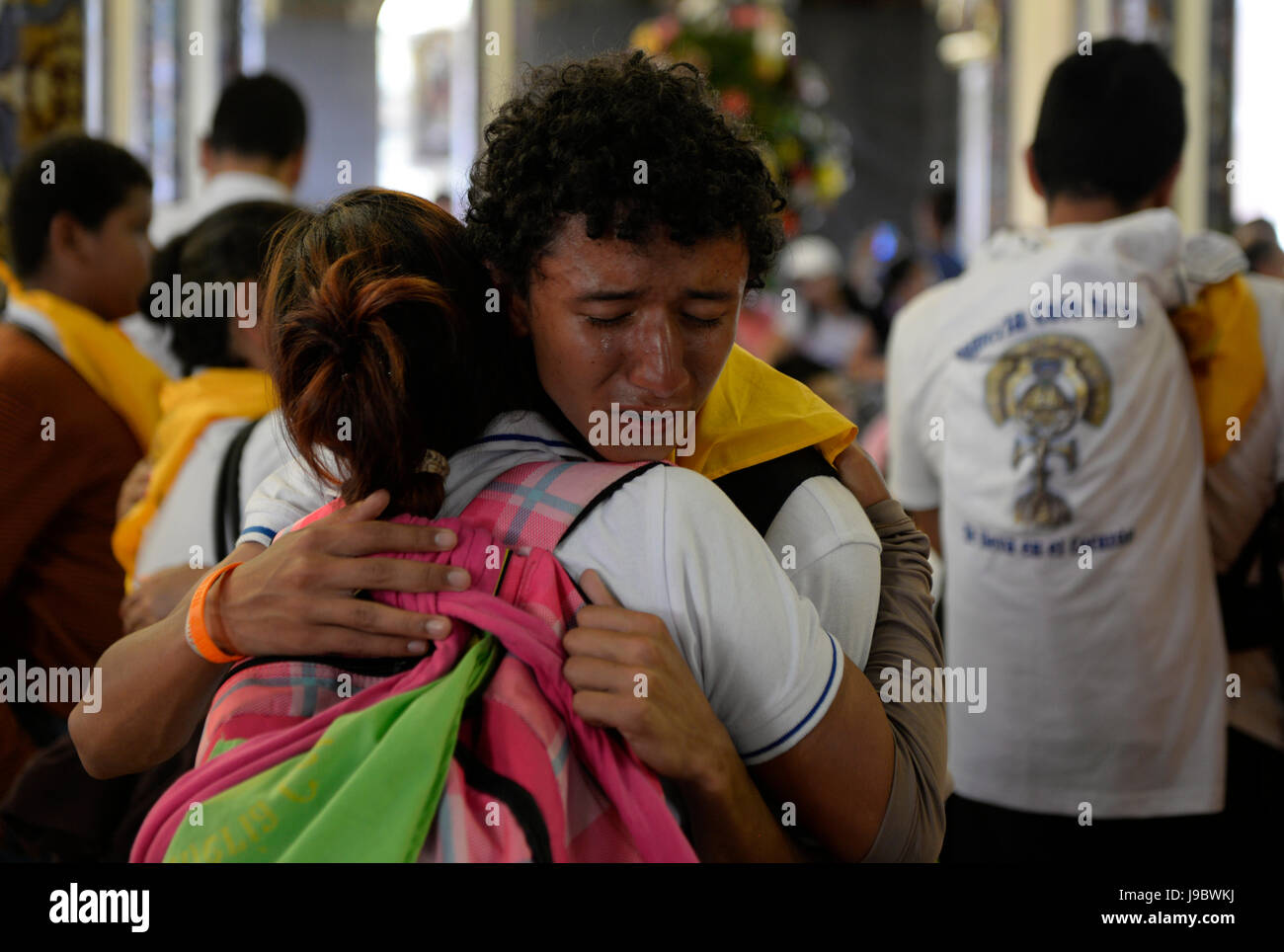 Pilgrims hug in the Basillica de Nuestra Señora Los Angeles after the ...
