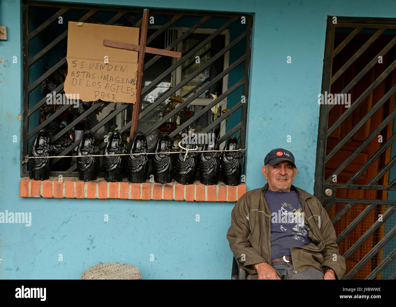 A man sells replicas of "La Negrita", the patron saint of Costa Rica ...