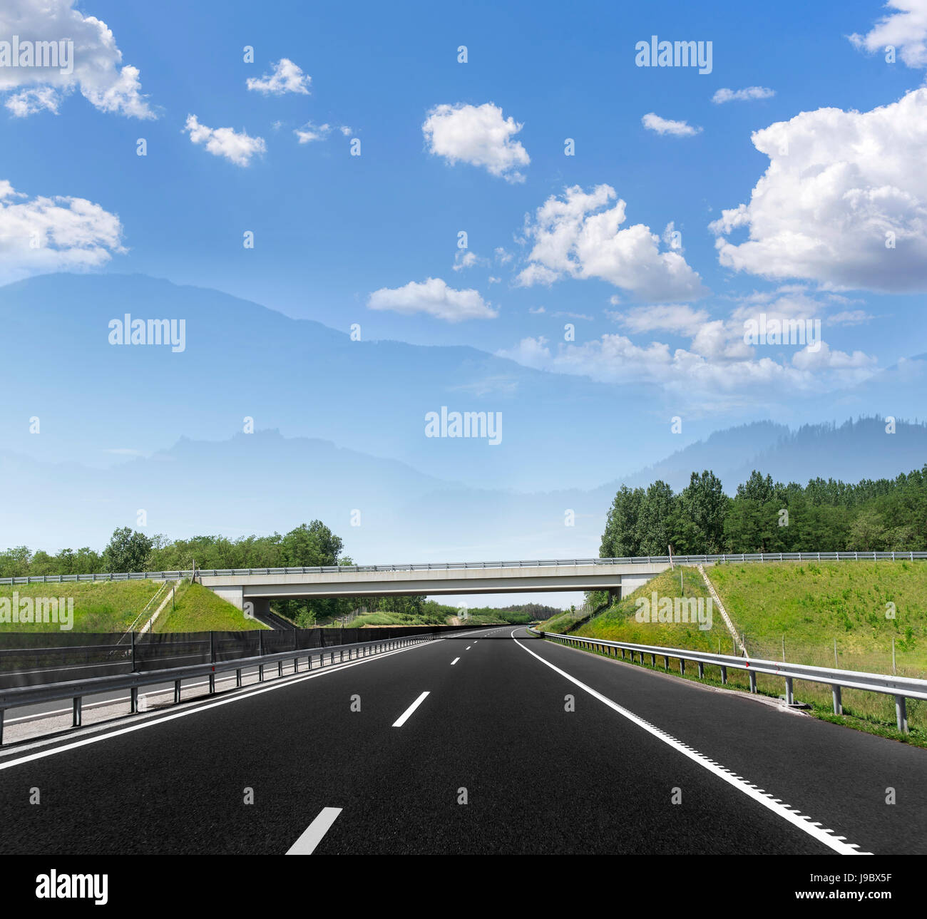 Highway between the forest and the mountains Stock Photo - Alamy