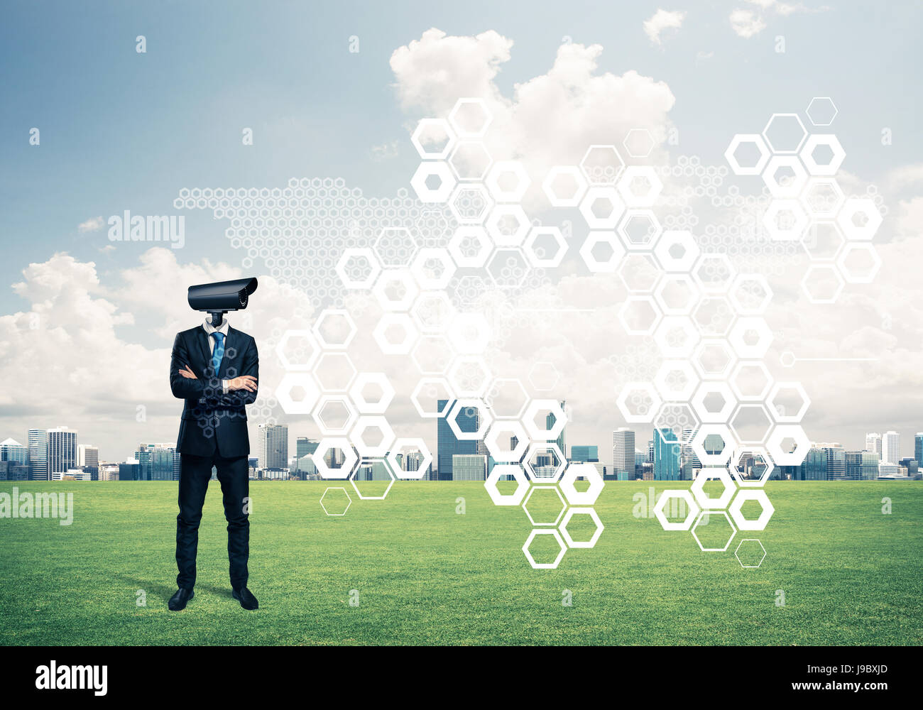 Camera headed man standing on green grass against modern citysca Stock ...