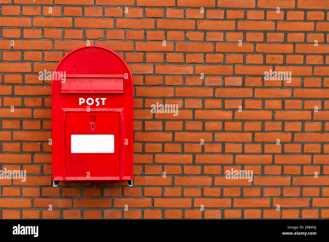 red mailbox on stone wall Stock Photo - Alamy