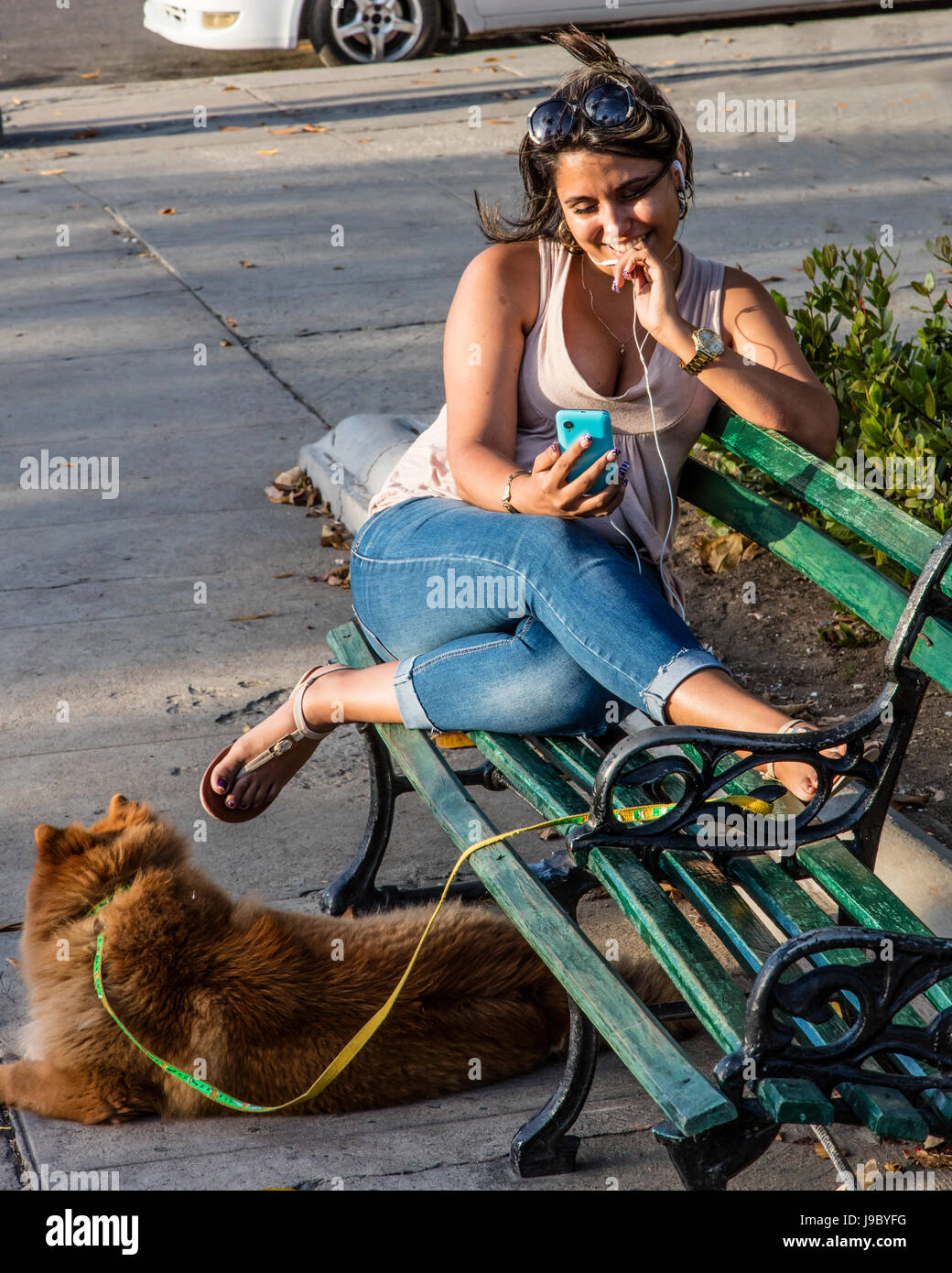 A Cuban woman enjoys talking on her cell phone in the PARQUE JOSE MARTI ...