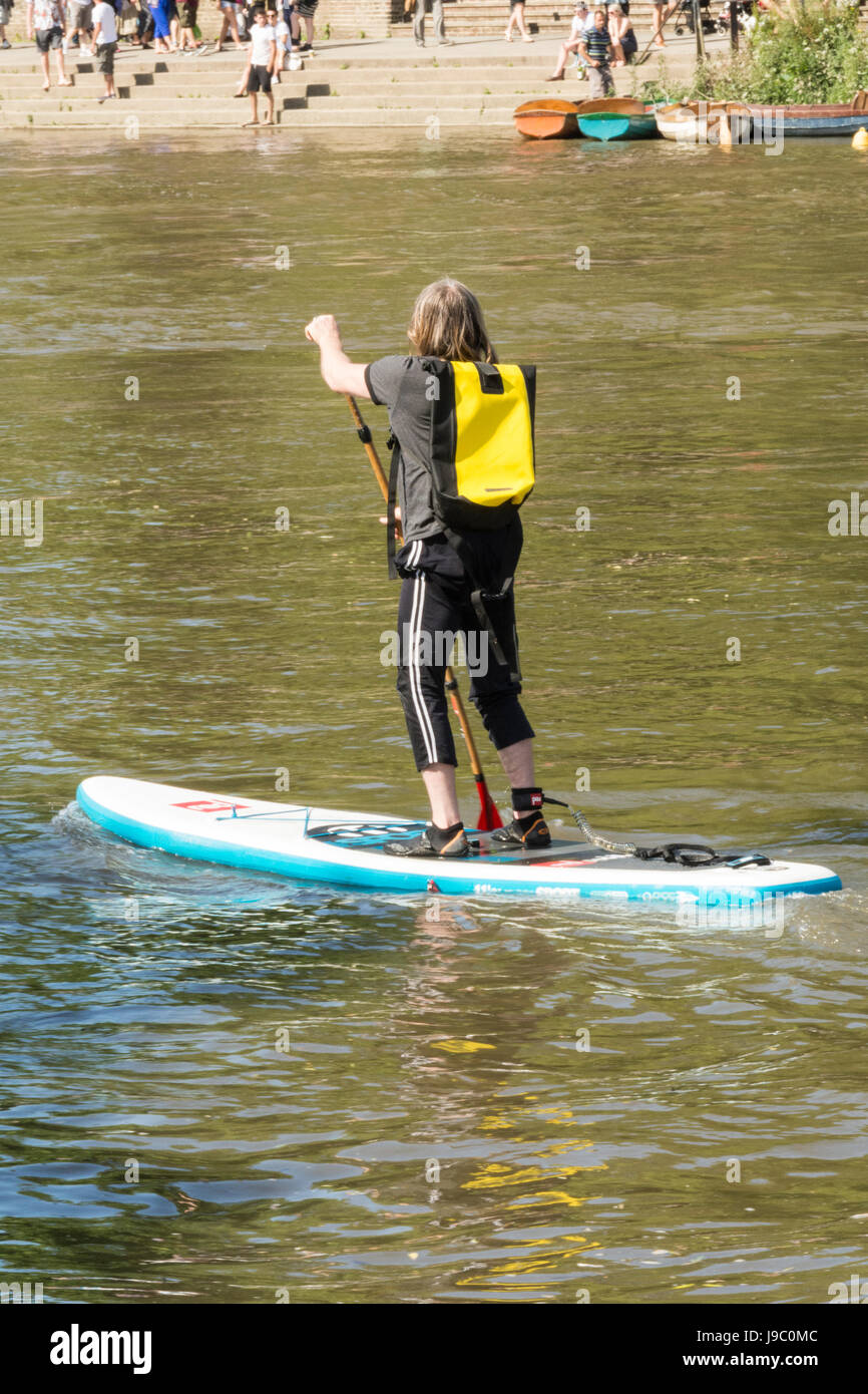 A man paddle boarding on the River Thames in Richmond, Surrey, UK Stock ...