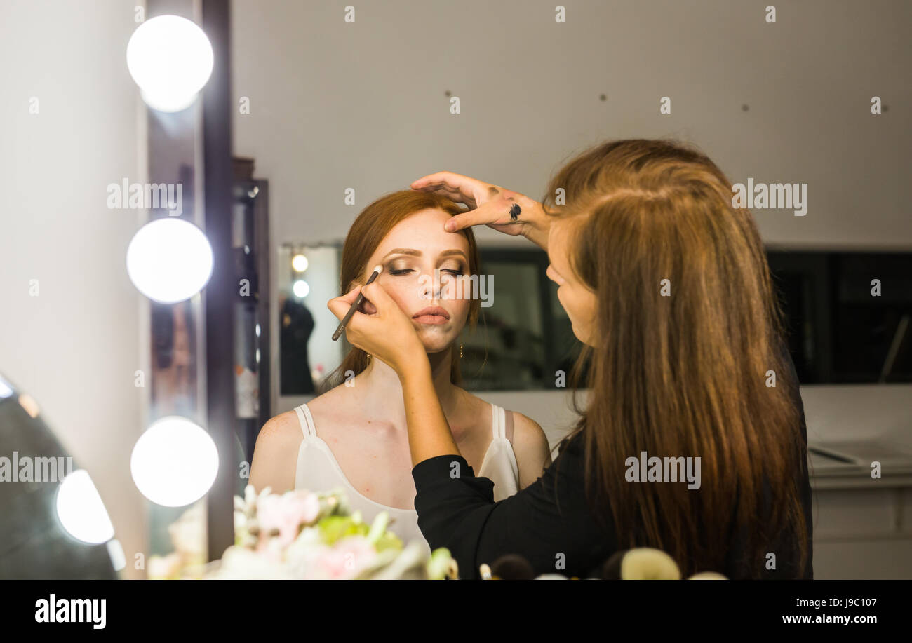 Make-up artist in the studio doing makeup beauty girl Stock Photo - Alamy