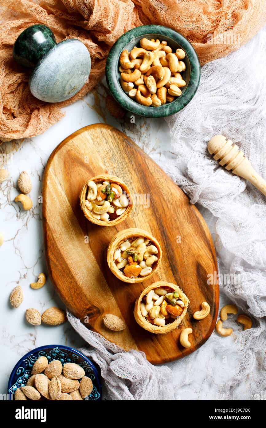 Nuts with honey, dessert in sweet nest form, assorted nuts like cashews ...