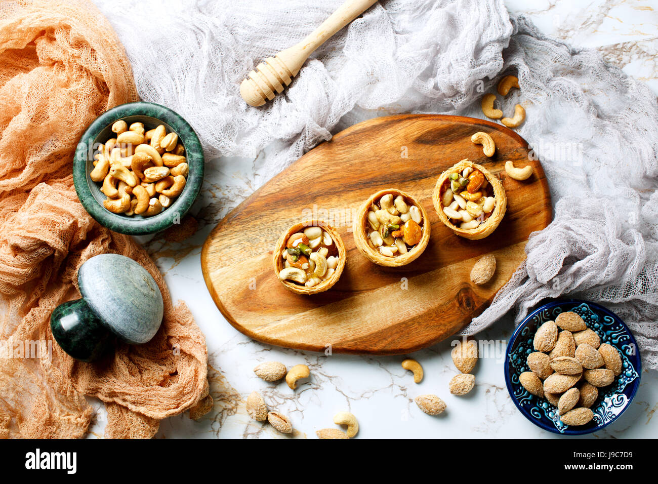 Nuts with honey, dessert in sweet nest form, assorted nuts like cashews ...