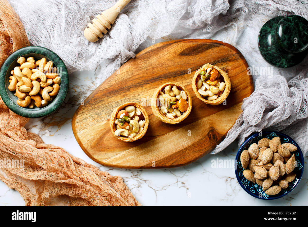 Nuts with honey, dessert in sweet nest form, assorted nuts like cashews ...