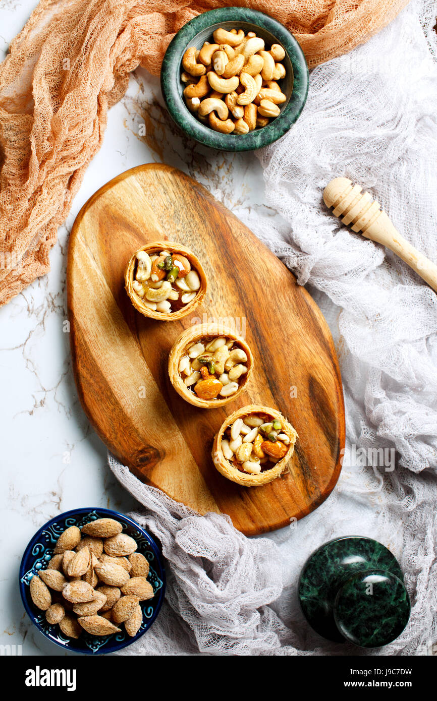 Nuts with honey, dessert in sweet nest form, assorted nuts like cashews ...