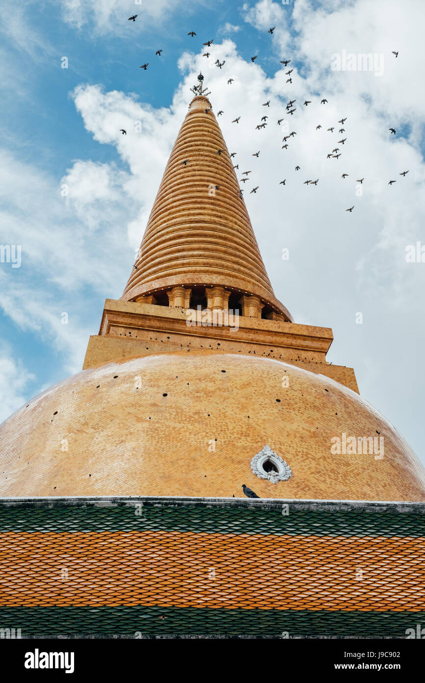 Thai pagoda with blue sky and birds flying around Stock Photo - Alamy