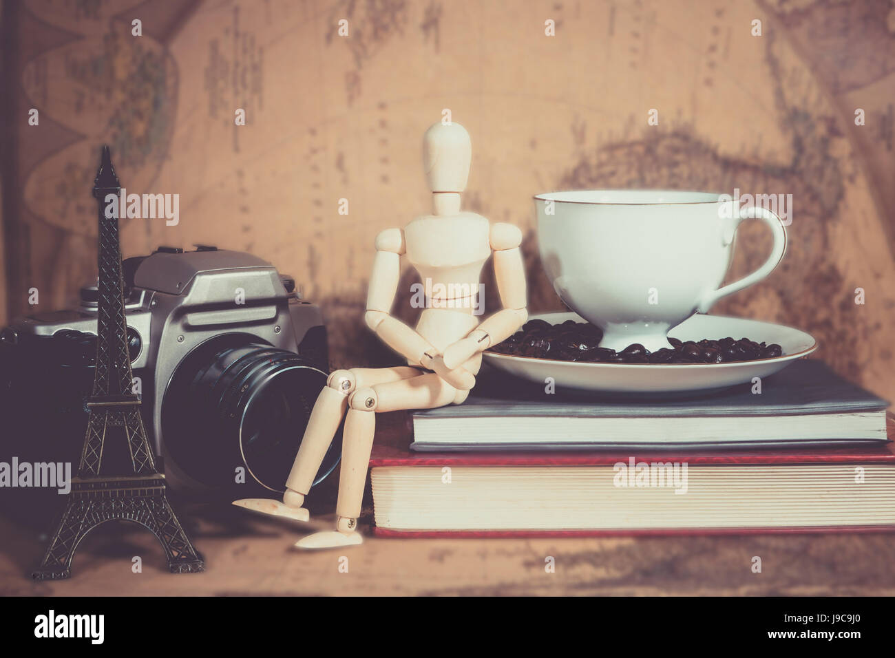 Camera Cup coffee on books a map background Stock Photo - Alamy
