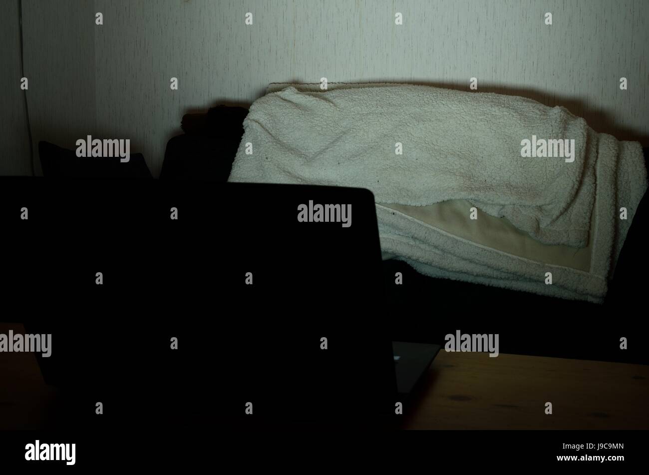 Computer screen illuminating room at night Stock Photo - Alamy