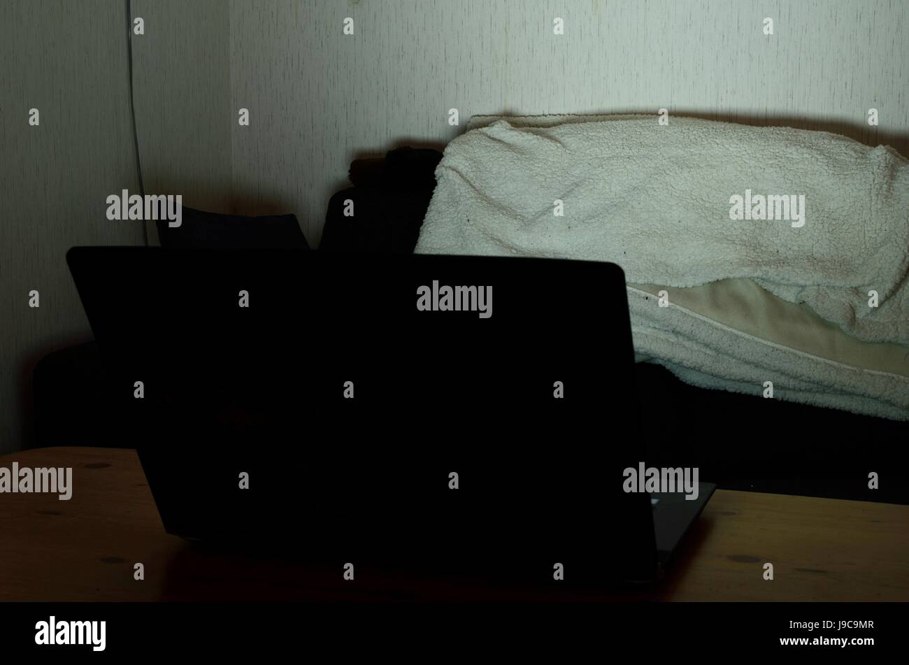 Computer screen illuminating room at night Stock Photo - Alamy