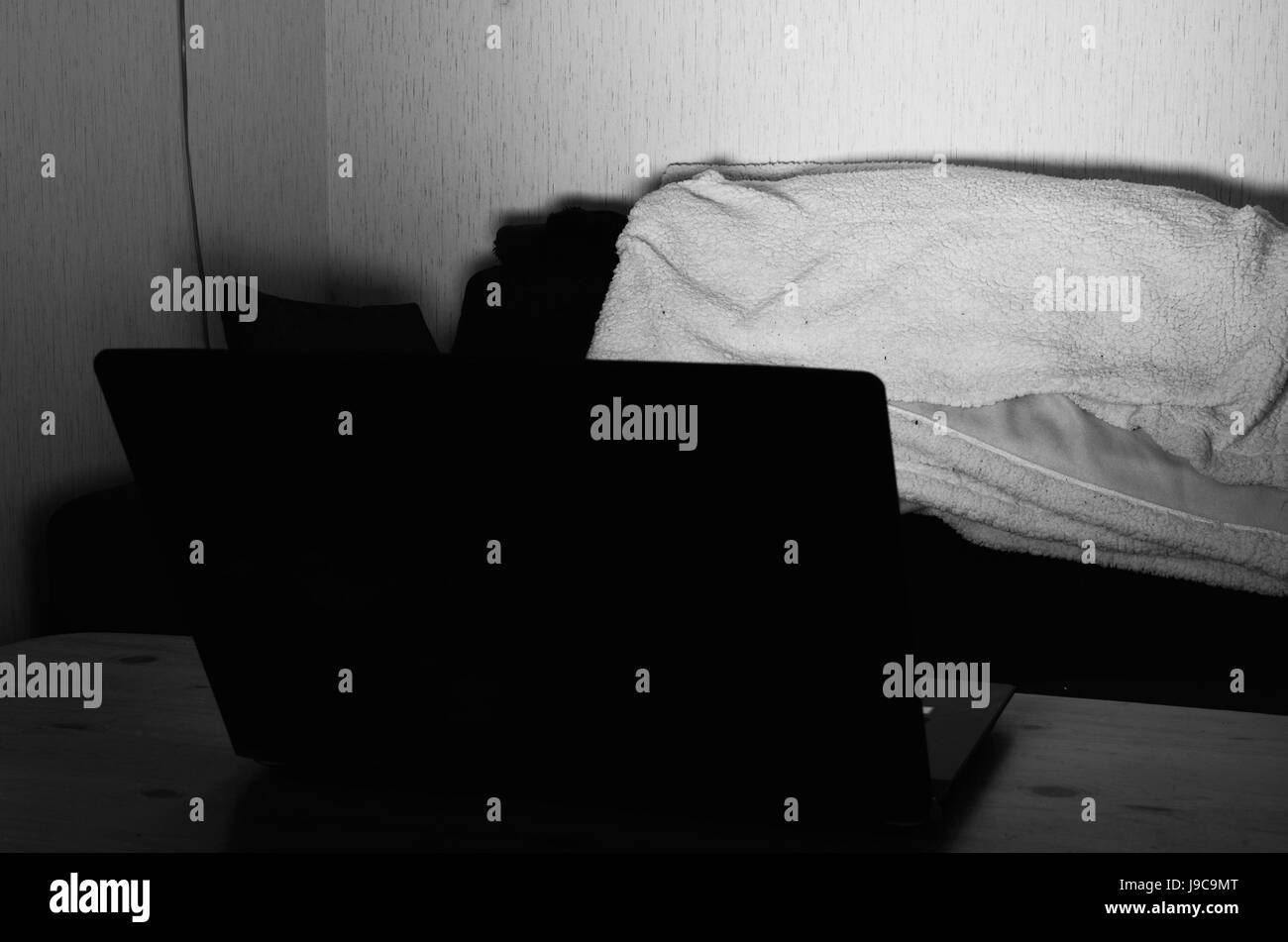 Computer screen illuminating room at night Stock Photo - Alamy