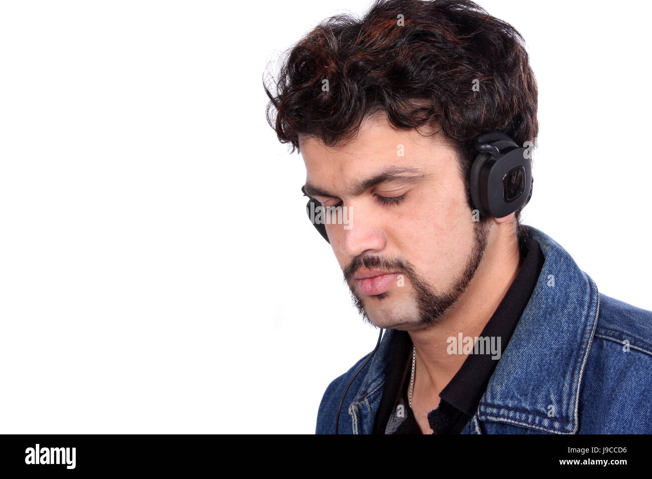 Indian guy listening music headset hi-res stock photography and images ...