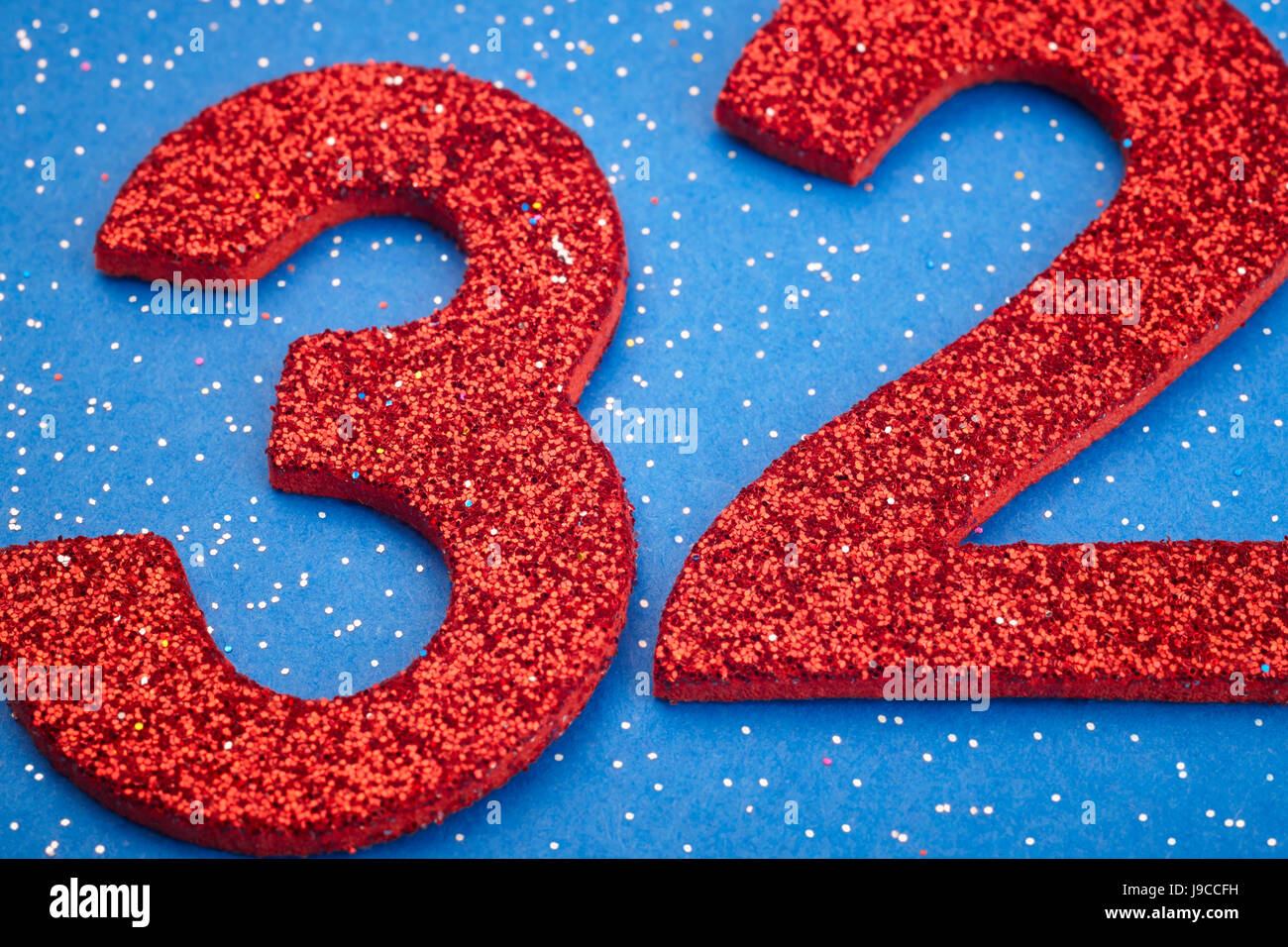 Number thirtytwo red color over a blue background. Anniversary ...