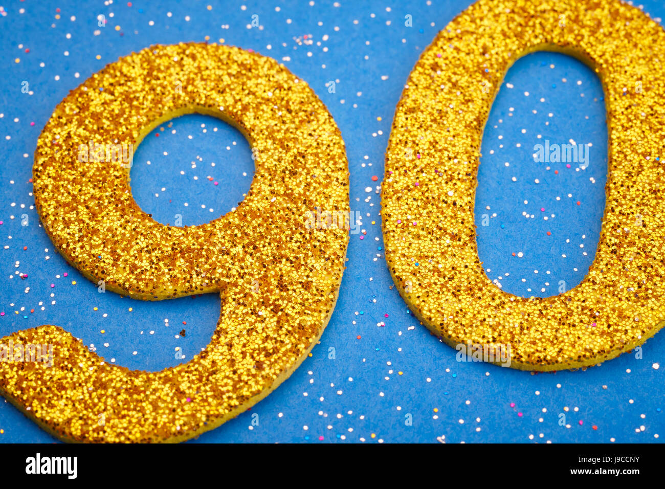 Number ninety yellow color over a blue background. Anniversary ...