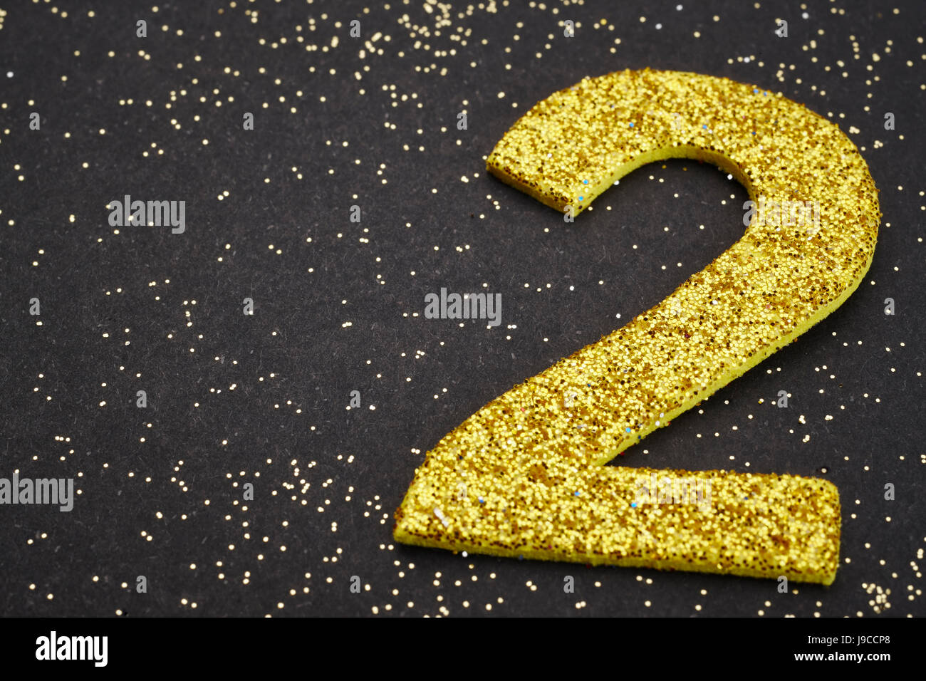Number two golden color over a black background. Anniversary ...