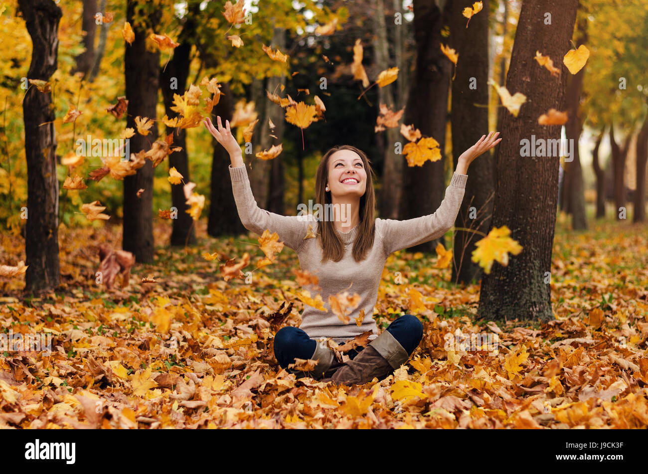 Autumn girl playing in city park. Fall woman portrait of happy lovely ...